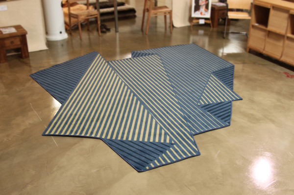 A Rug That Resembles a Folded Sheet of Paper